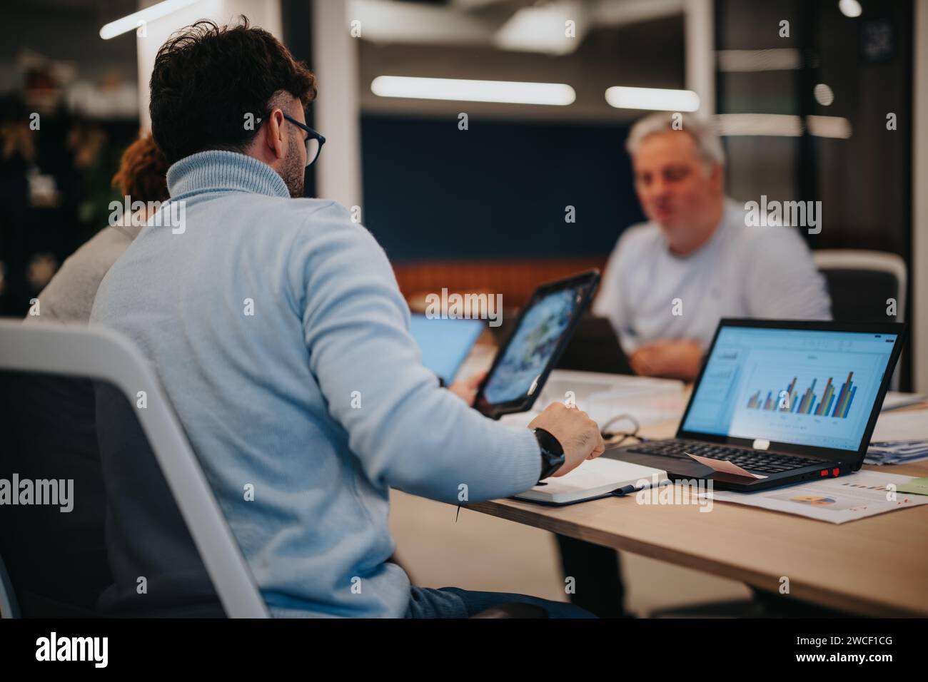 Business professionals collaborate on business strategies and data ...