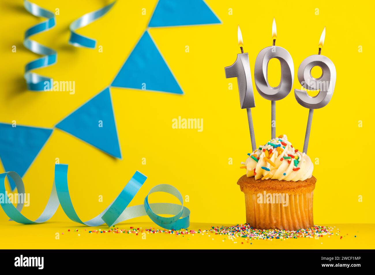 Lighted birthday candle number 109 - Yellow background with blue ...