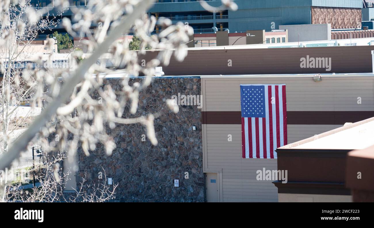 American flag hanging on side of building Stock Photo - Alamy
