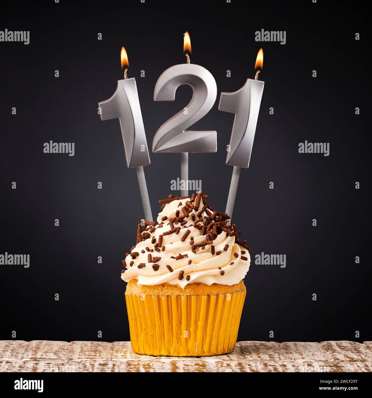 Birthday candle number 121 - Anniversary cupcake on black background ...