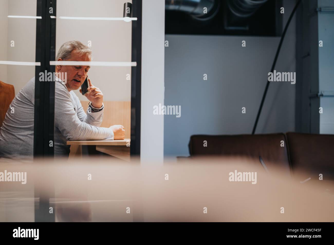 Business person discussing advertising strategies on phone booth while ...