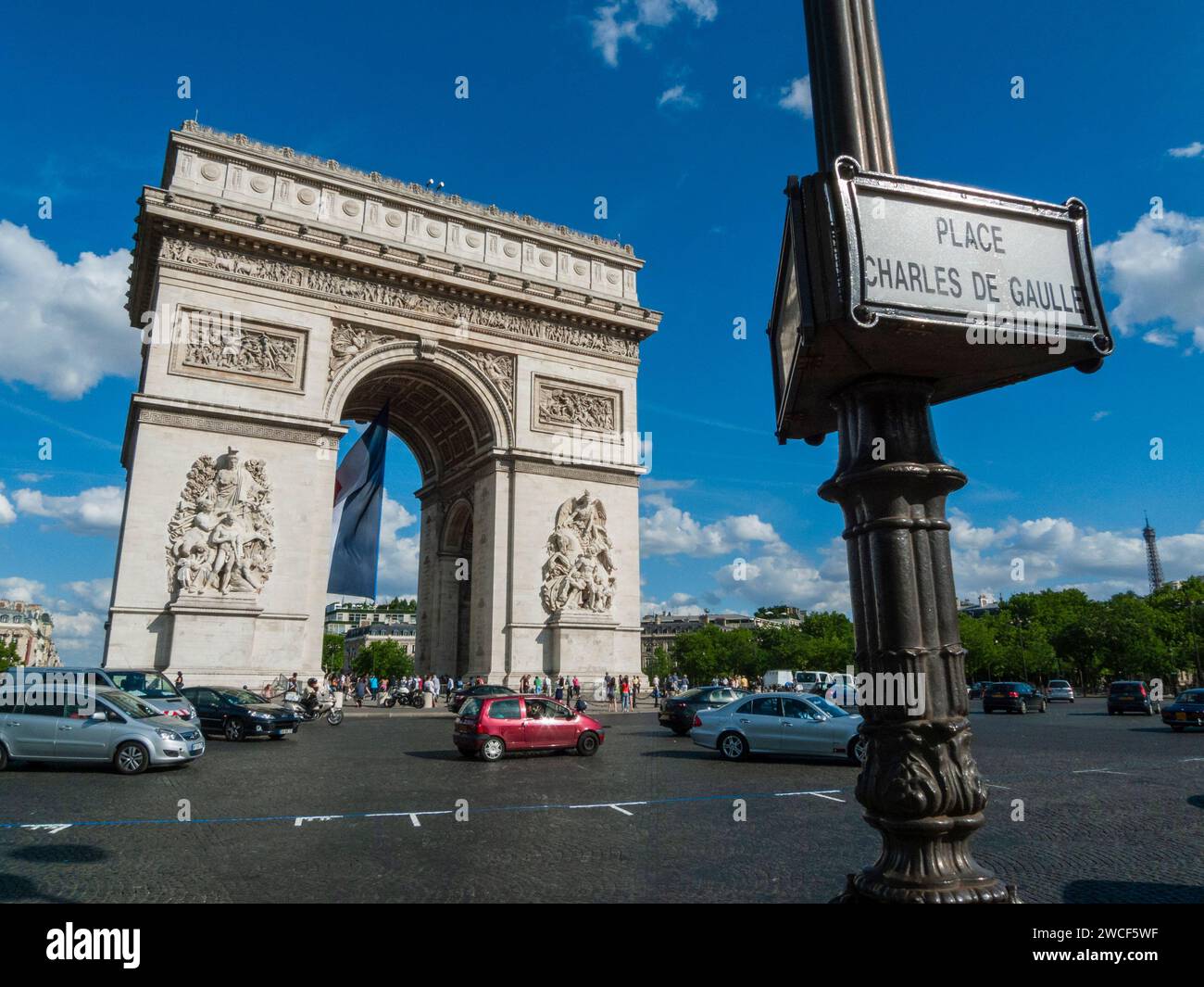 Place Charles de Gaulle sign with the iconic Arc de Triomphe in the background on a sunny day ...