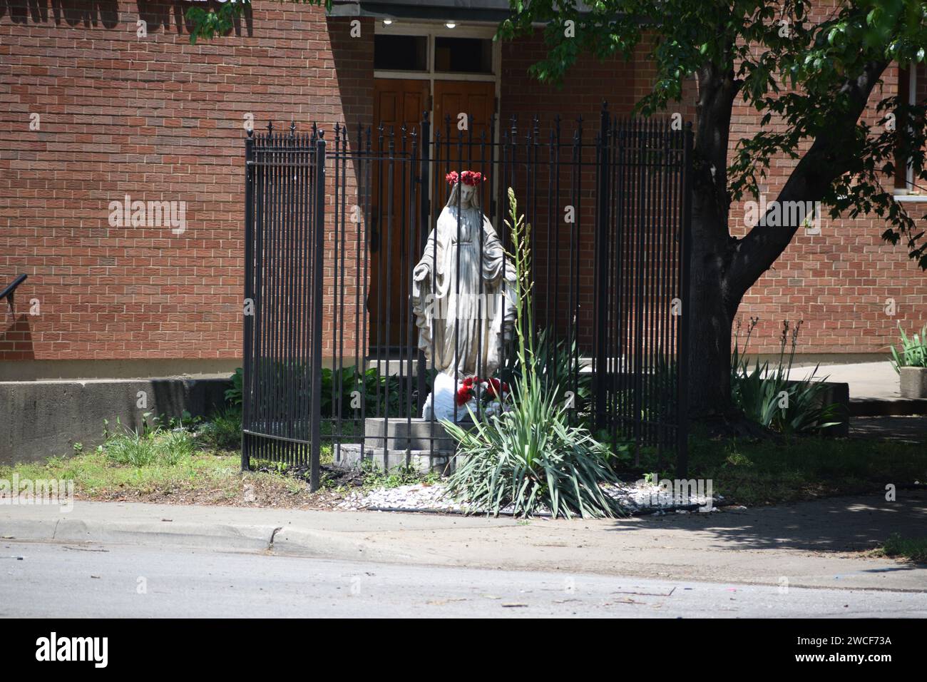 A Virgin Mary statue behind bars at Saint Monica Catholic Church in ...