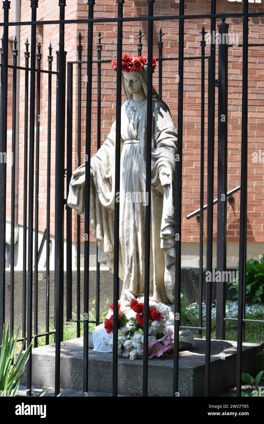 A Virgin Mary statue behind bars at Saint Monica Catholic Church in ...
