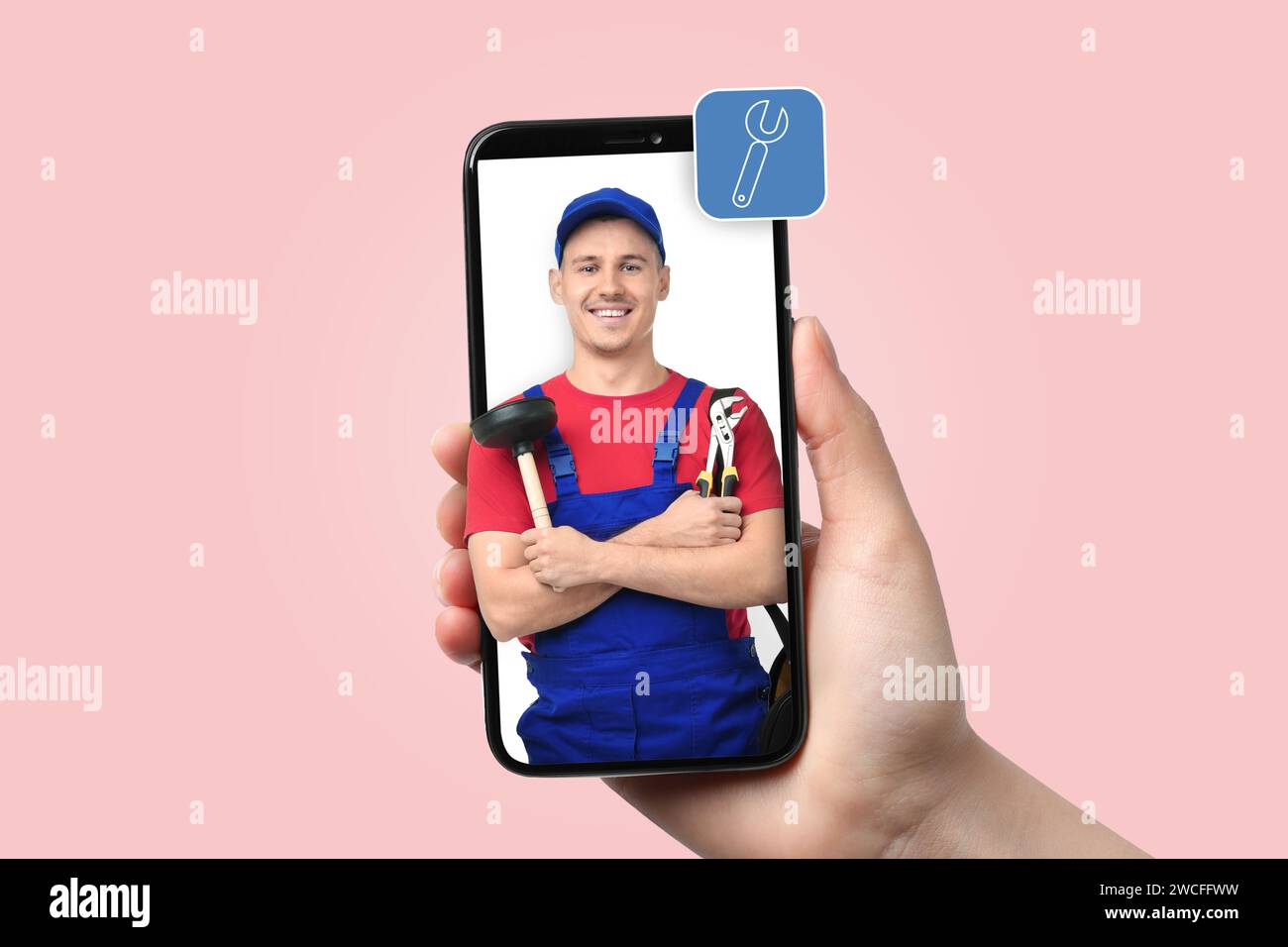 Find plumber. Woman using mobile phone on pink background, closeup ...
