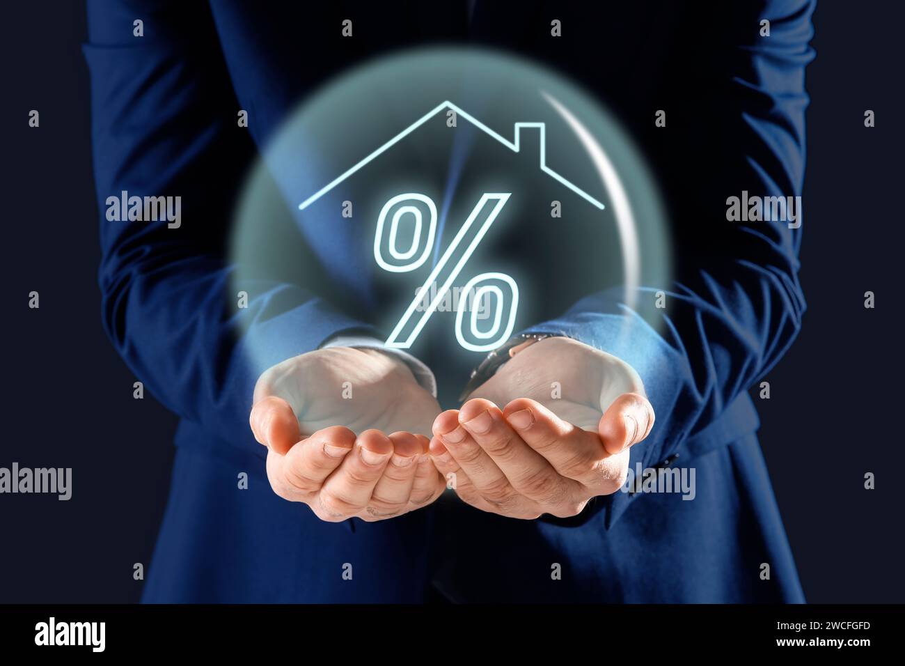 Mortgage. Man holding sphere with percent sign and house roof on dark ...
