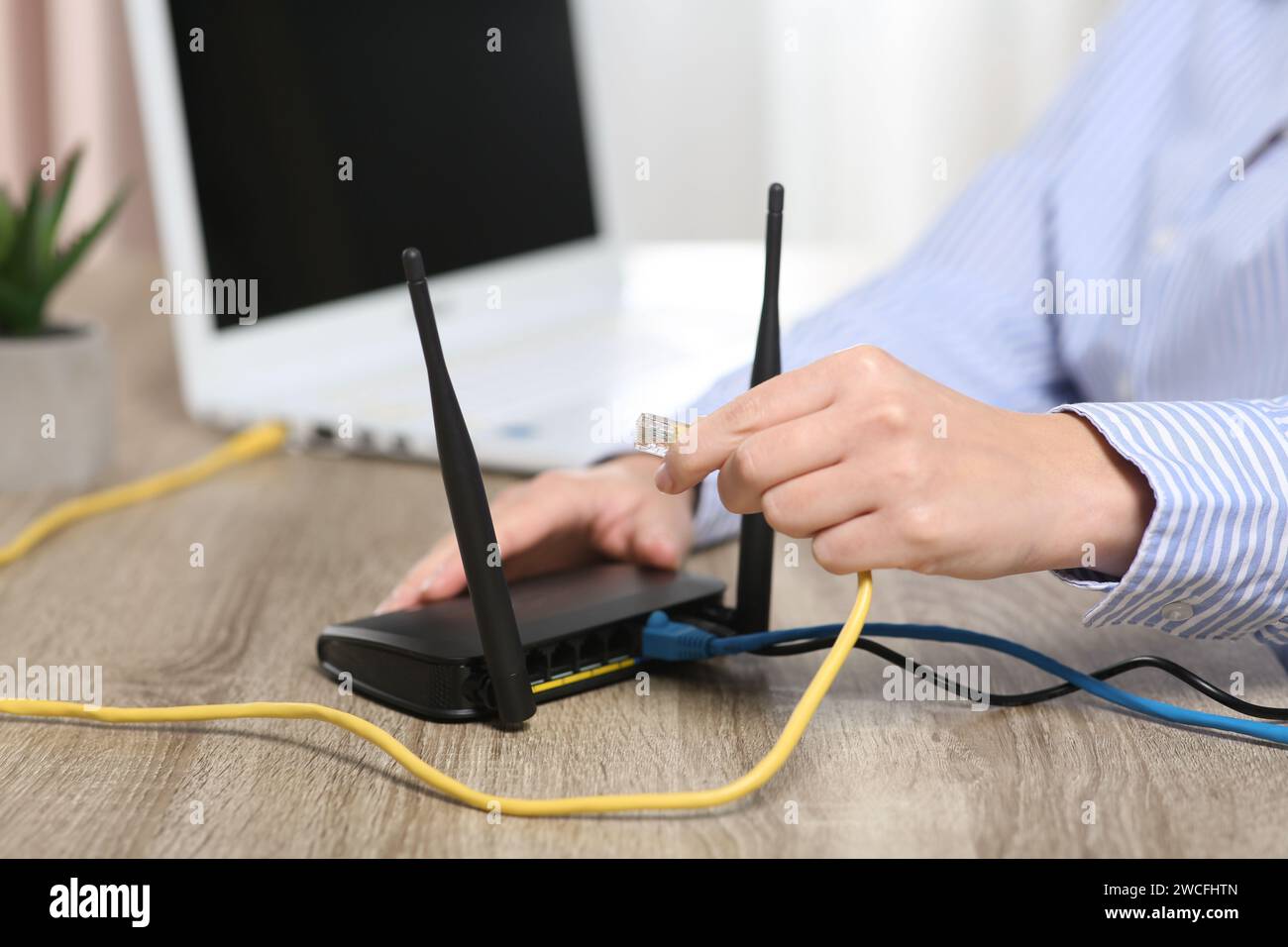Hands ethernet cable router hi-res stock photography and images - Alamy