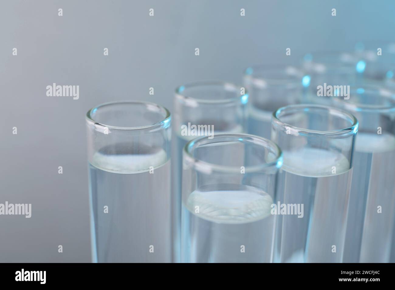 Laboratory analysis. Test tubes with liquid samples on color background ...