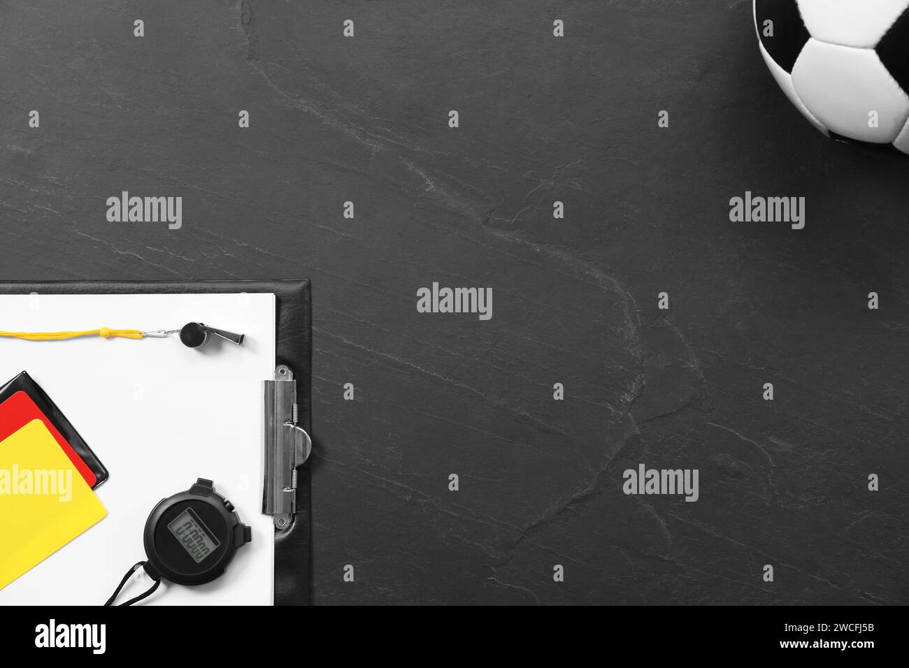 Soccer ball and different referee equipment on black table, top view ...