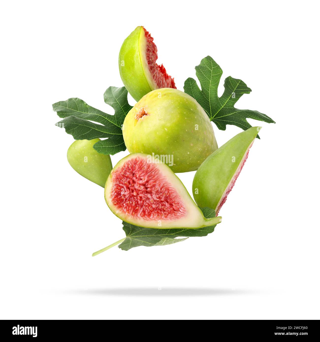 Ripe figs and green leaves falling on white background Stock Photo - Alamy