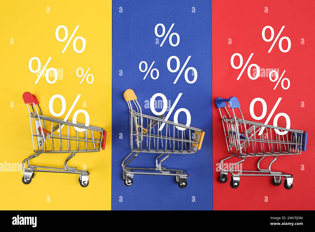 Discount offer. Mini shopping carts and percent signs on colorful ...