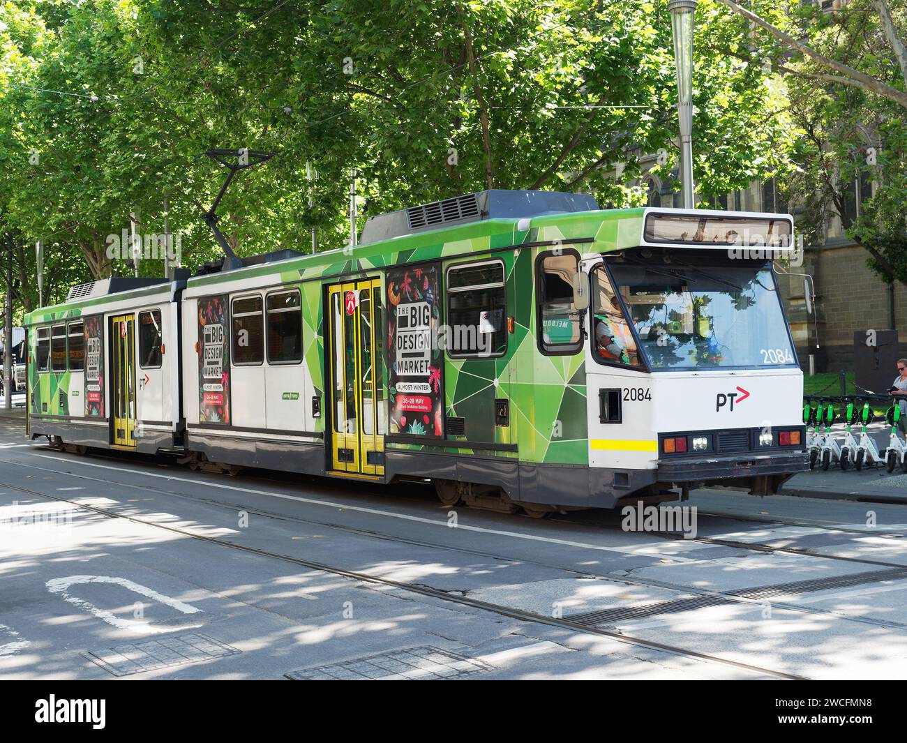 View of a city tram waiting at the busy junction of Flinders and ...