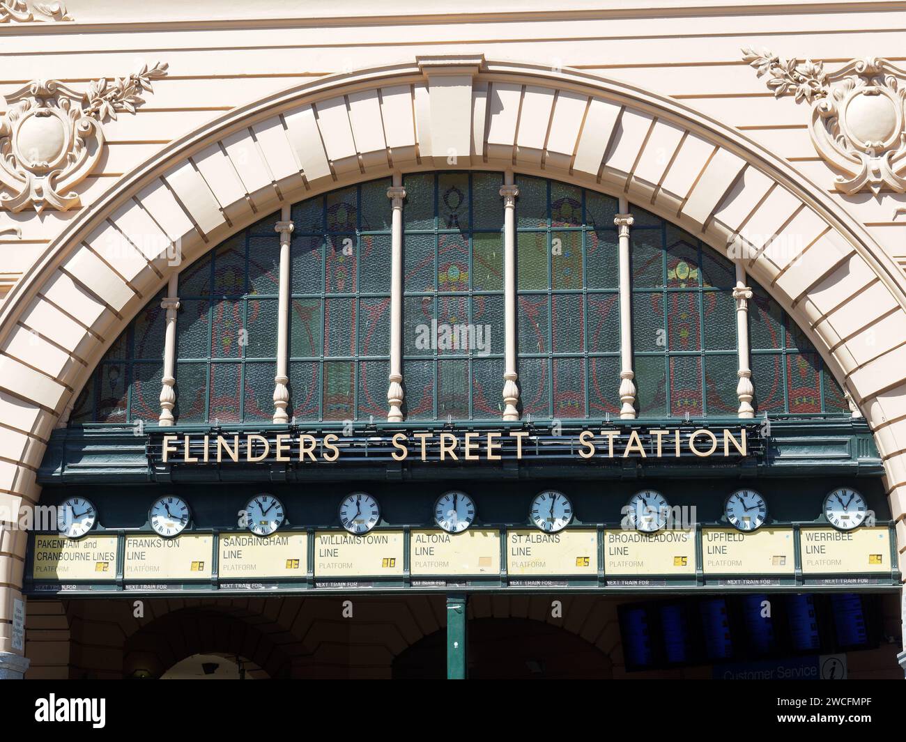 Close-up front view of name sign and clocks above the main entrance to ...