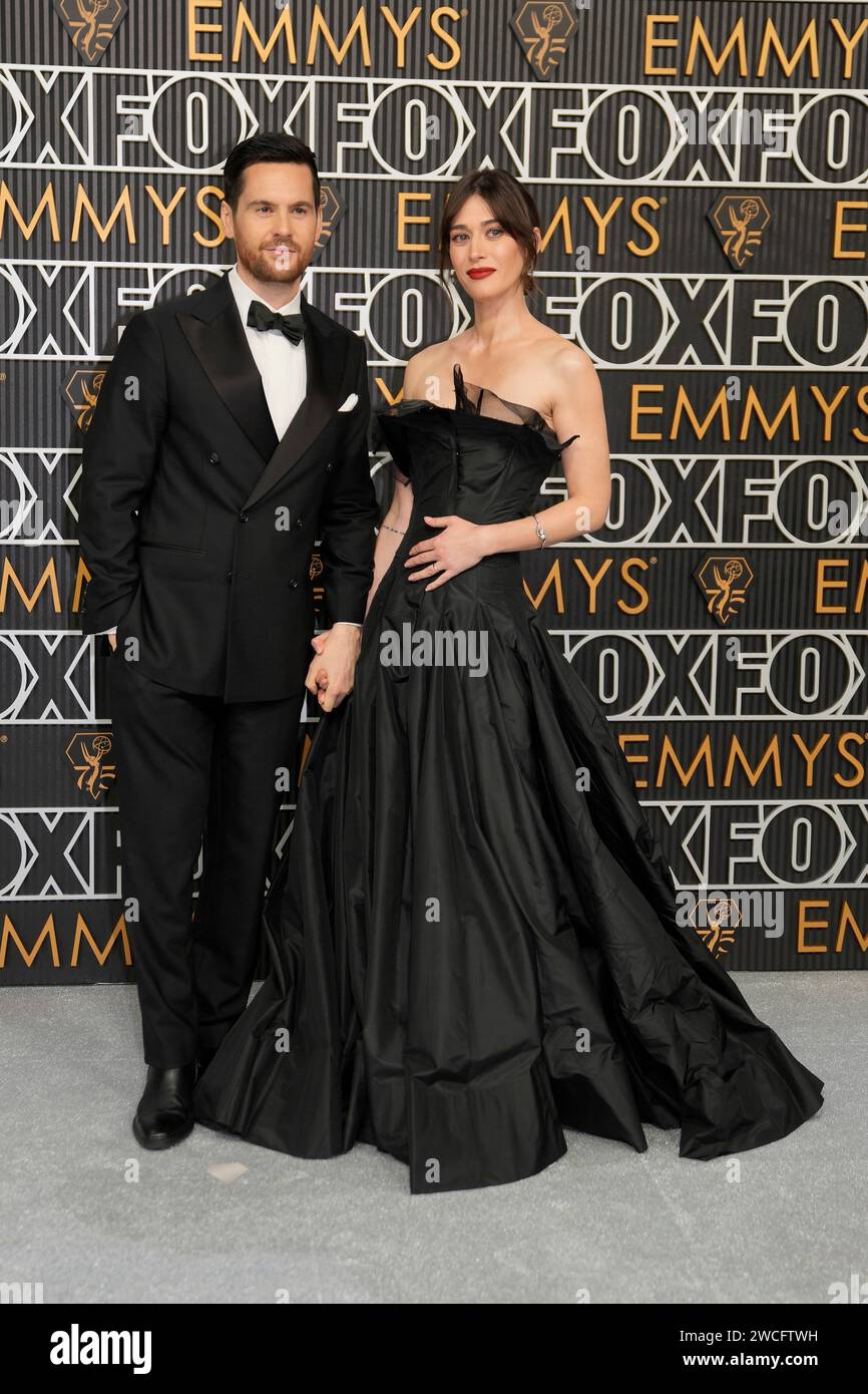 Tom Riley, left, and Lizzy Caplan arrive at the 75th Primetime Emmy ...