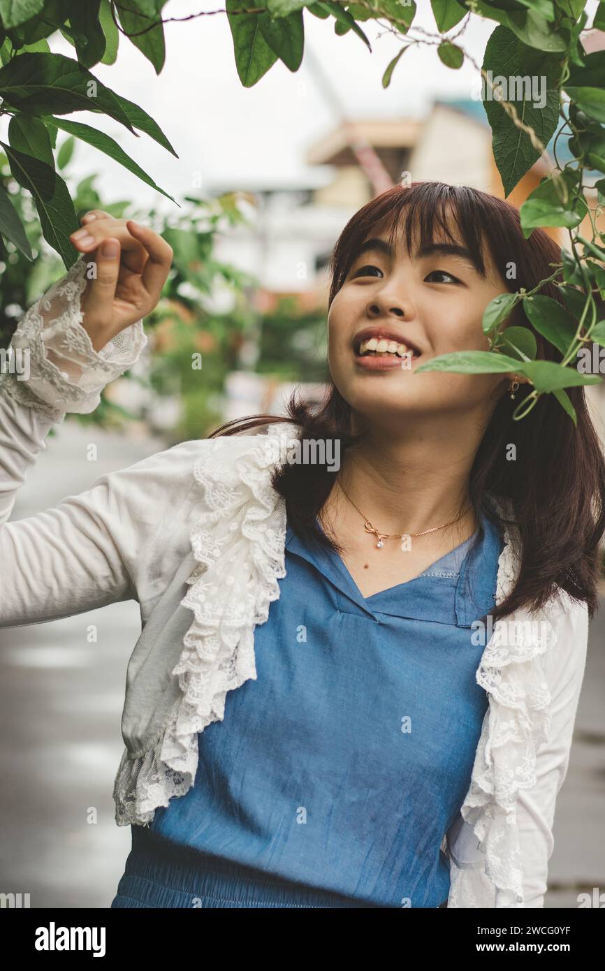 Person standing under tree hi-res stock photography and images - Alamy