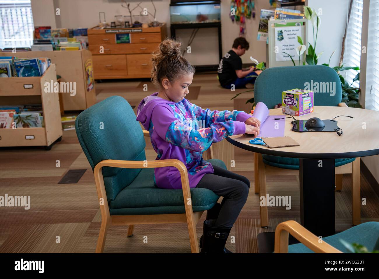 Kansas City, Kansas. Nine year old bi-racial girl working with ...
