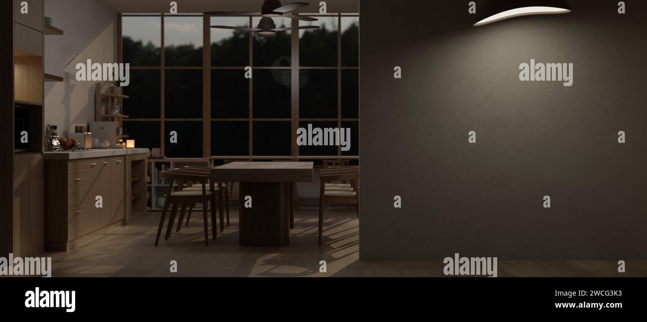 A modern spacious dark kitchen at night with a dining table and an ...