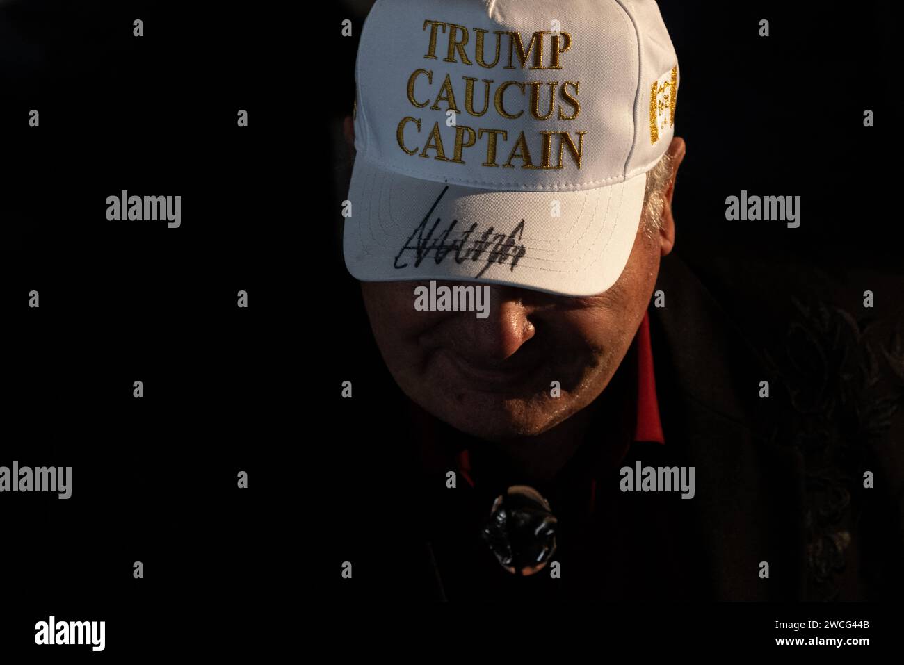 Ankeny, USA. 15th Jan, 2024. A man wears a "Trump Caucus Captain" hat ...