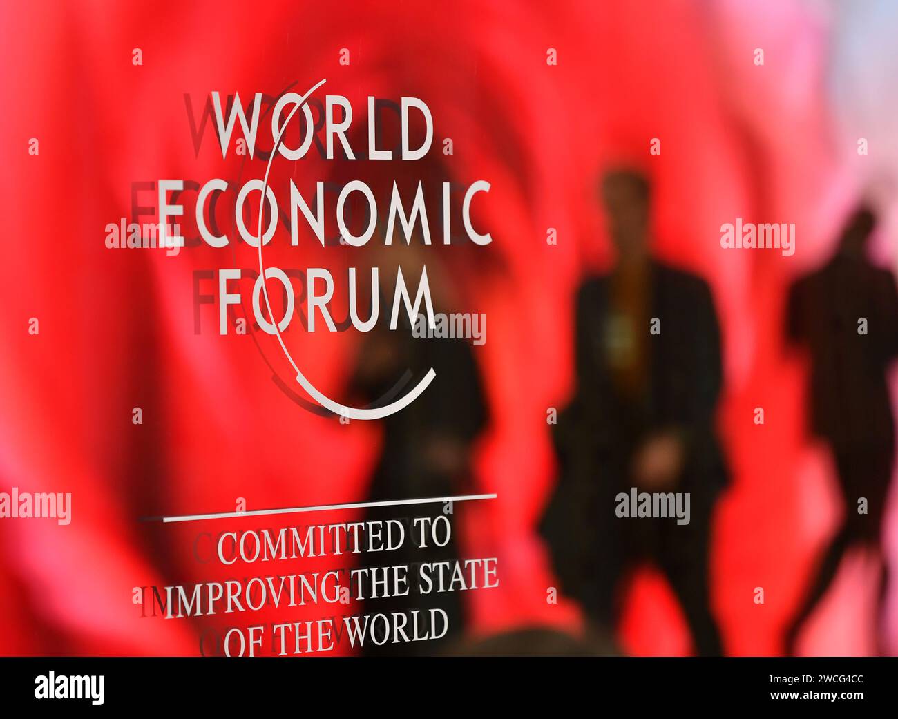 Davos, Switzerland. 15th Jan, 2024. People walk past the logo of the ...