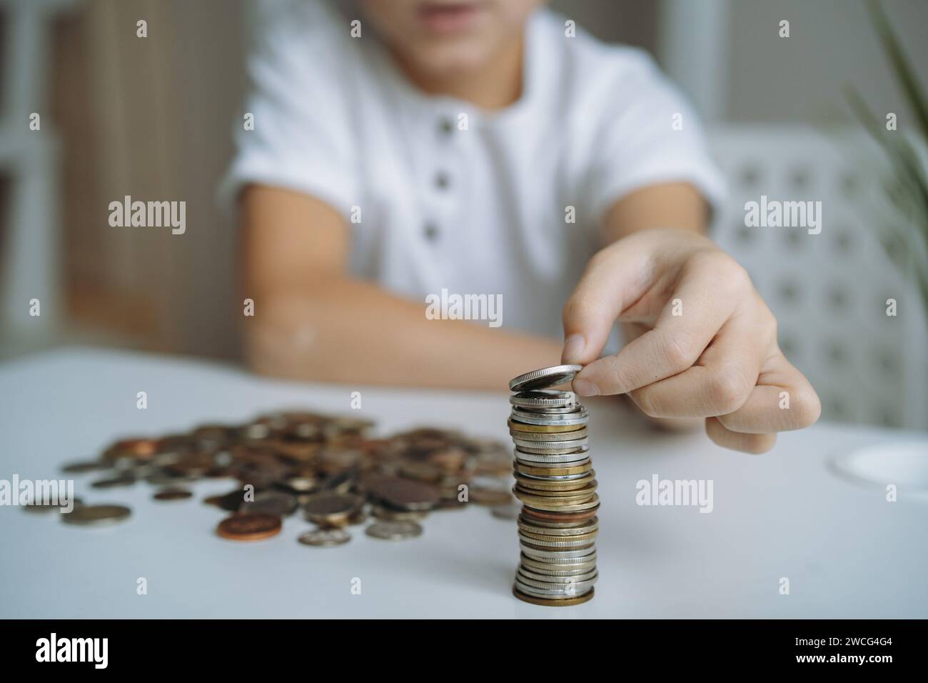 boy making pyramide of coins. ABC of finance. boy counting money Stock ...