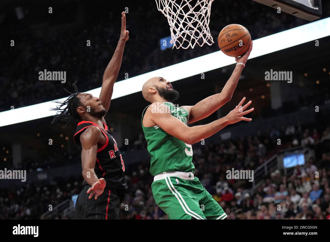 Boston Celtics guard Derrick White (9) drives to the basket as Toronto Raptors guard Immanuel ...