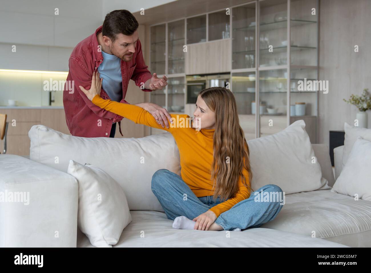 Offended upset woman wife pushes angry man husband away in heated home ...