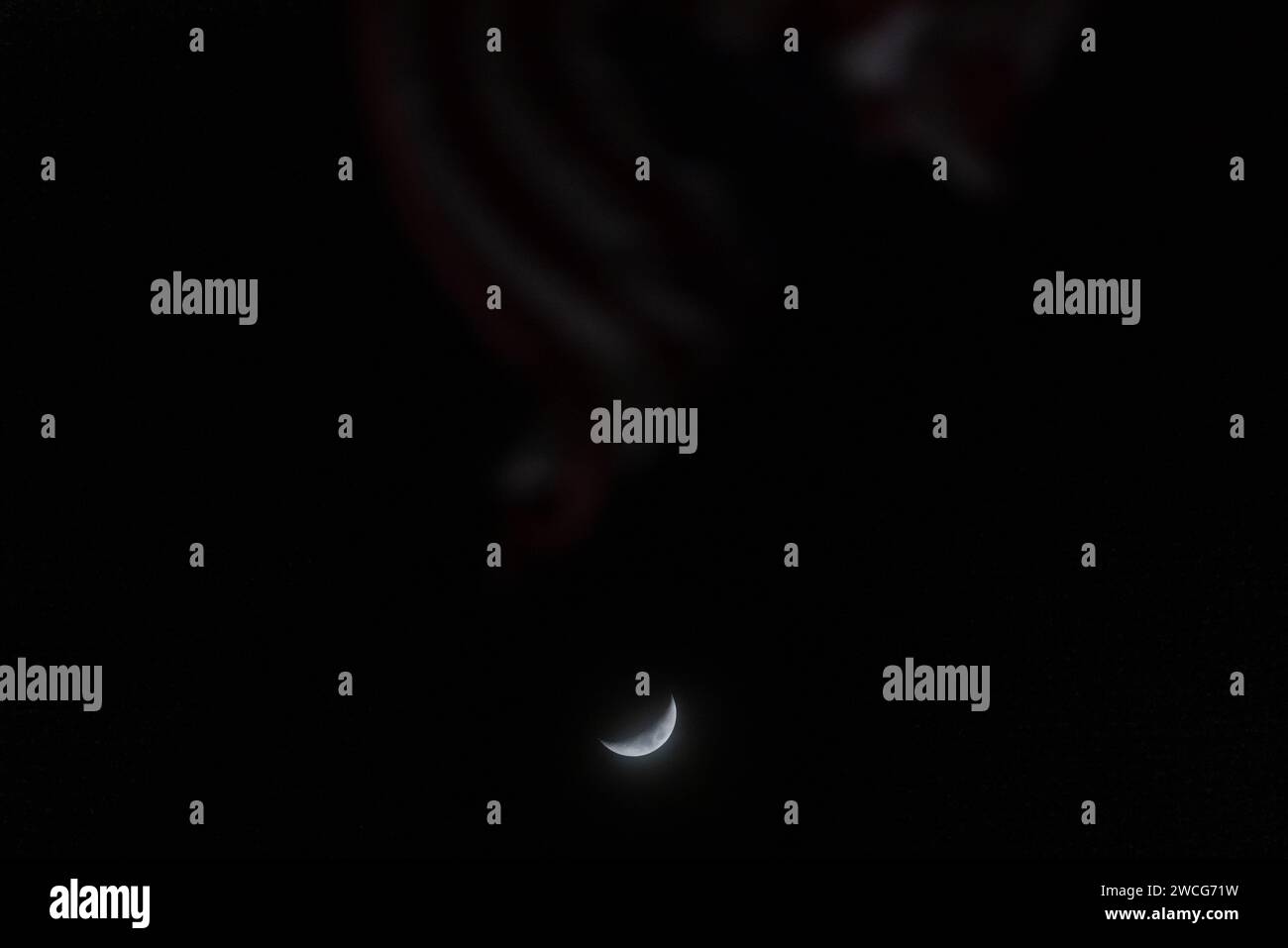 Des Moines, USA. 15th Jan, 2024. The moon sets under an American flag ...
