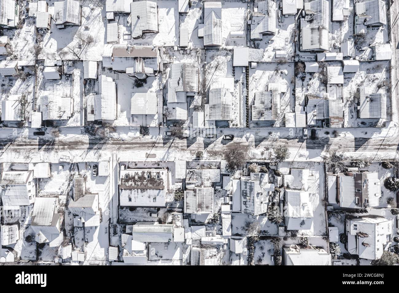 snow-covered rooftops in suburbs residential area. aerial top view from ...