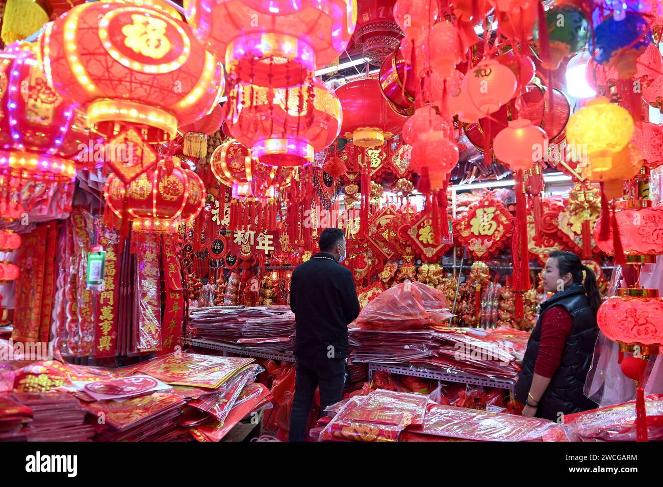 People shop Spring Festival decorations at a market in Qingdao City ...