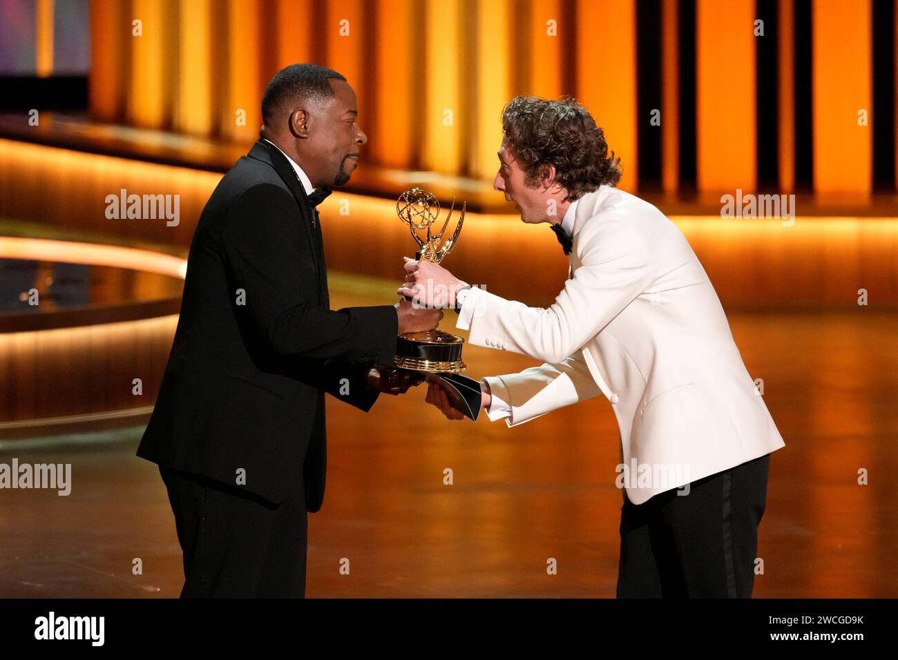 Martin Lawrence, left, presents the award for outstanding lead actor in a comedy series to ...