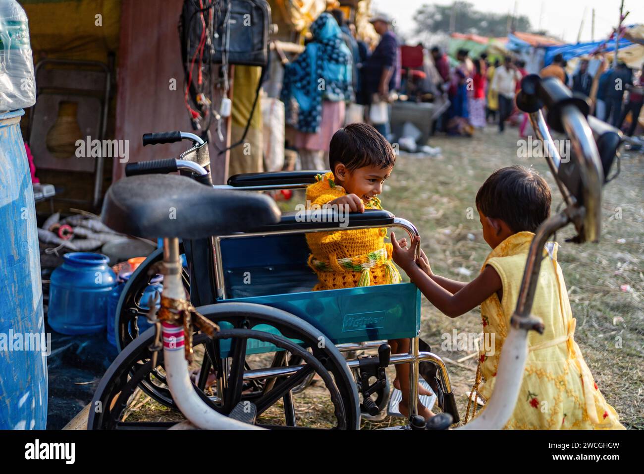 Jaynagar, India. 15th Jan, 2024. A child sits in a pre-owned wheelchair ...