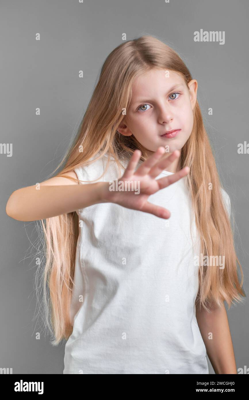 A little child girl showing a sign of protest or refusal with her hand ...