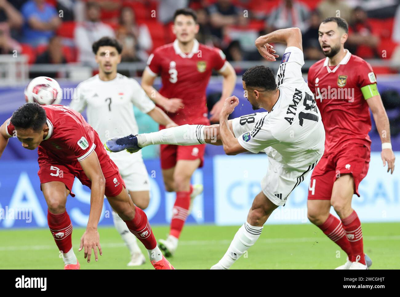 Doha, Qatar. 15th Jan, 2024. Aymen Hussein (C) of Iraq shoots to score ...