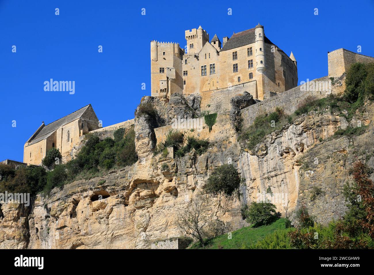 The fortified castle and the church of Beynac perched at the top of the ...
