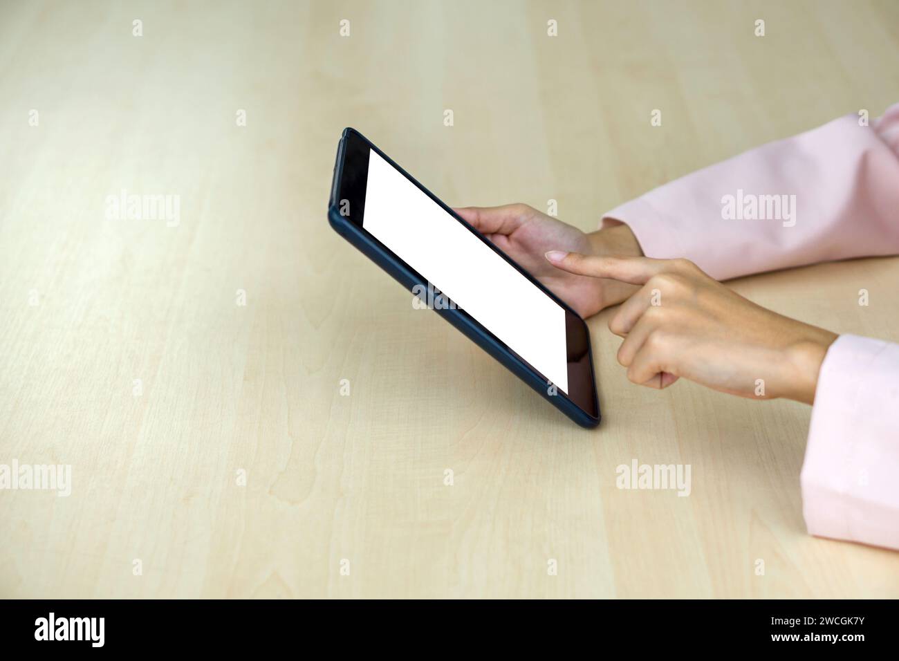 Closeup businesswoman hand holding tablet computer above a table ...