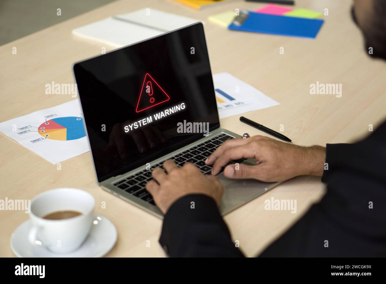 Back view of businessman in suit sit at desk in office, looks worried ...