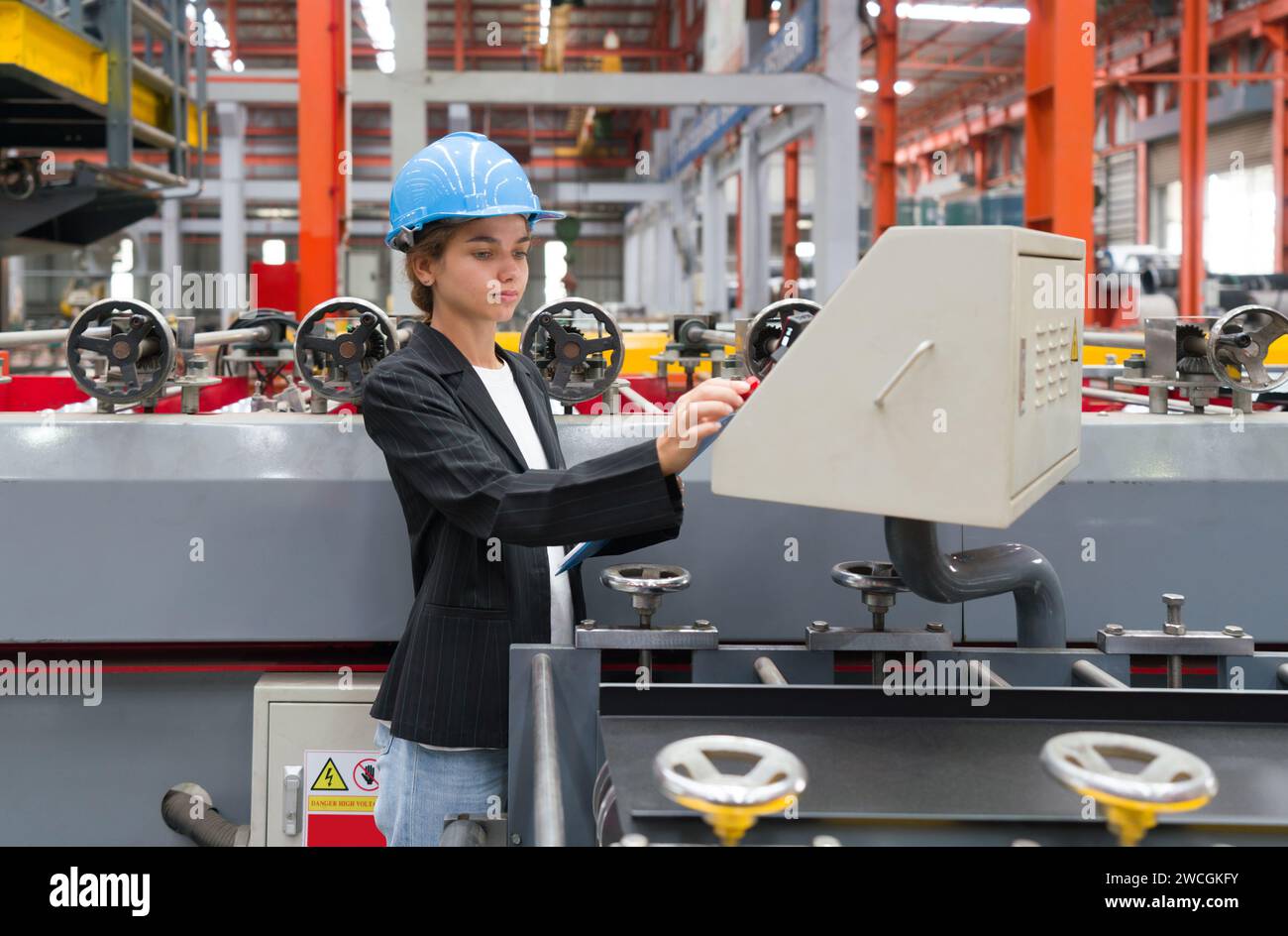 Factory worker managing industrial machine hi-res stock photography and ...