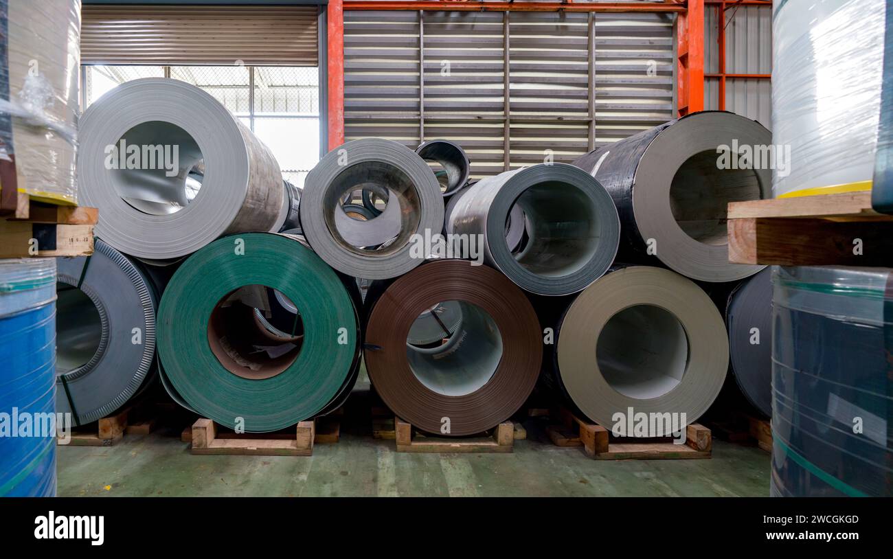 Steel coils stacked in a warehouse, ready for industrial use and ...
