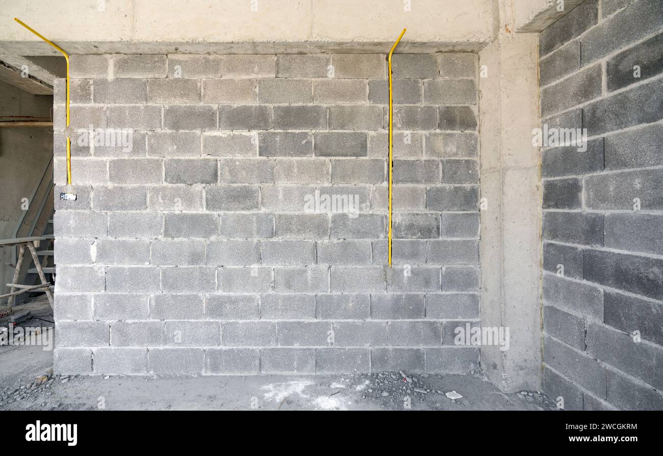 Unfinished room, exposed block and plaster on the wall, construction ...