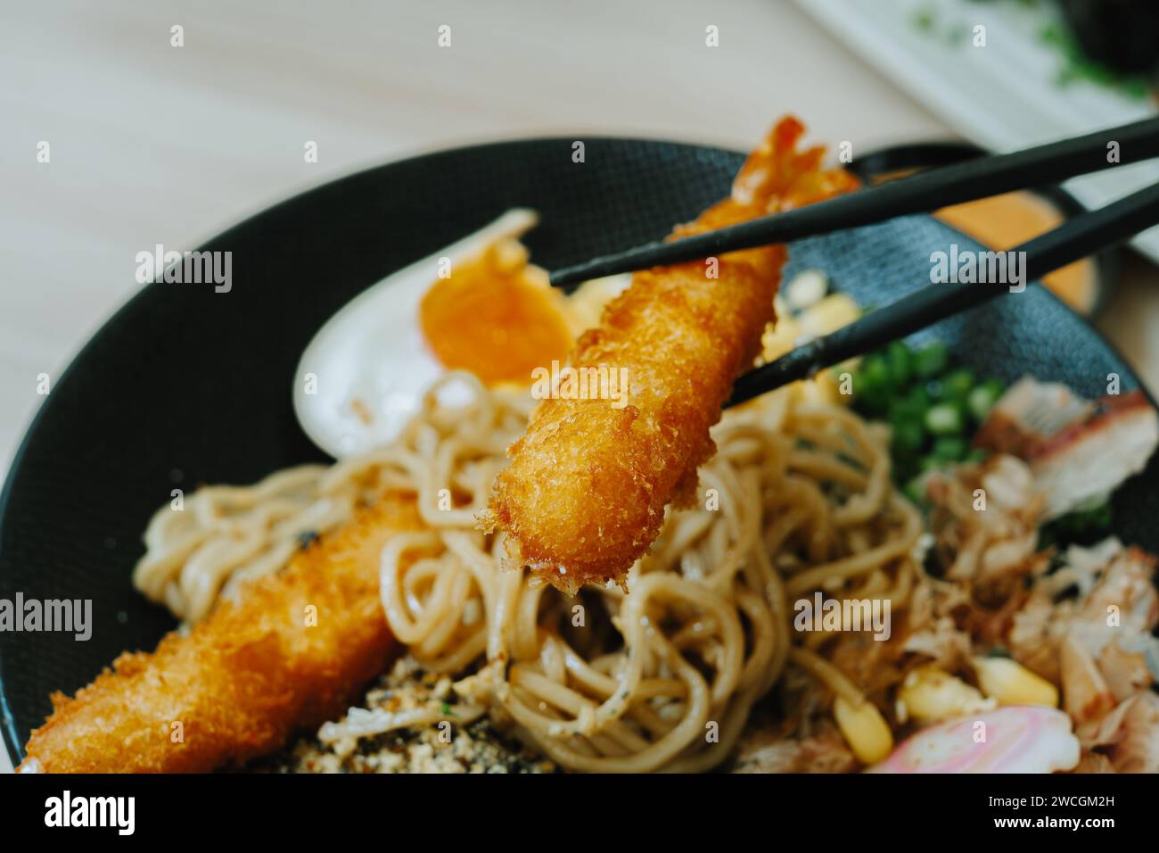 Ebi Furai taken using black chopsticks in a Yaki Ramen plate. Authentic ...