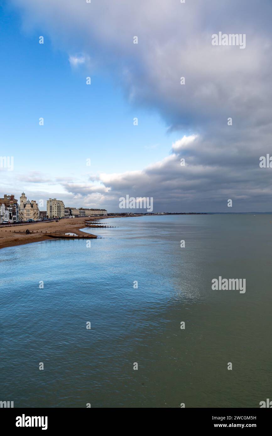A view along the beach from Eastbourne pier, with dramatic clouds ...