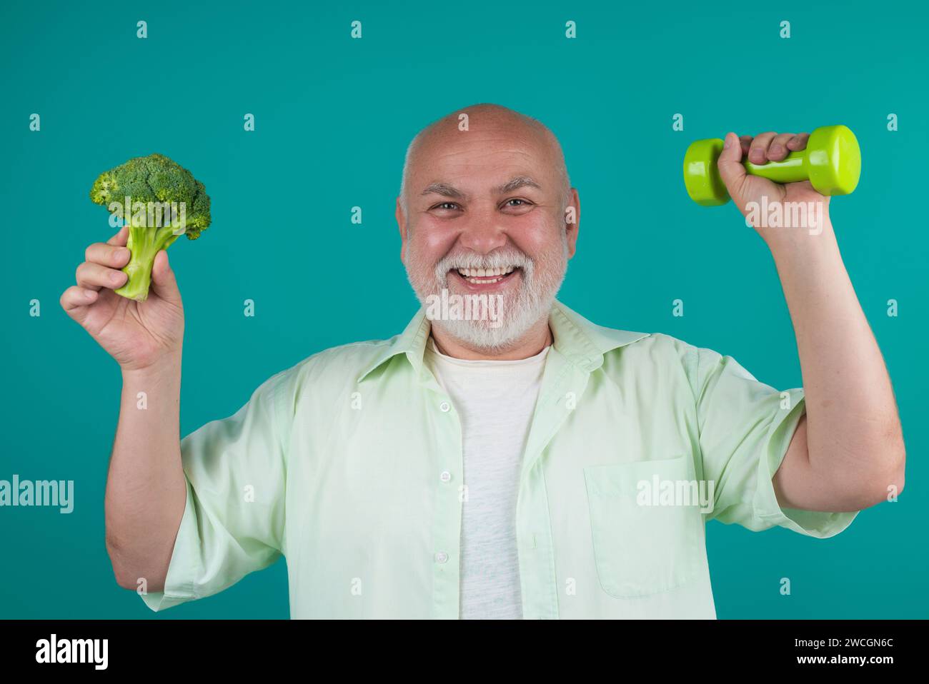 Healthy Senior. Healthy food. Power old mature man hold dumbbell and ...