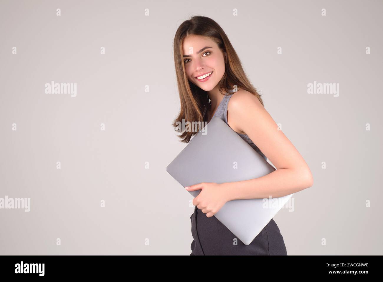 Happy Student. Woman Student in white t-shirt holding laptop and laptop ...