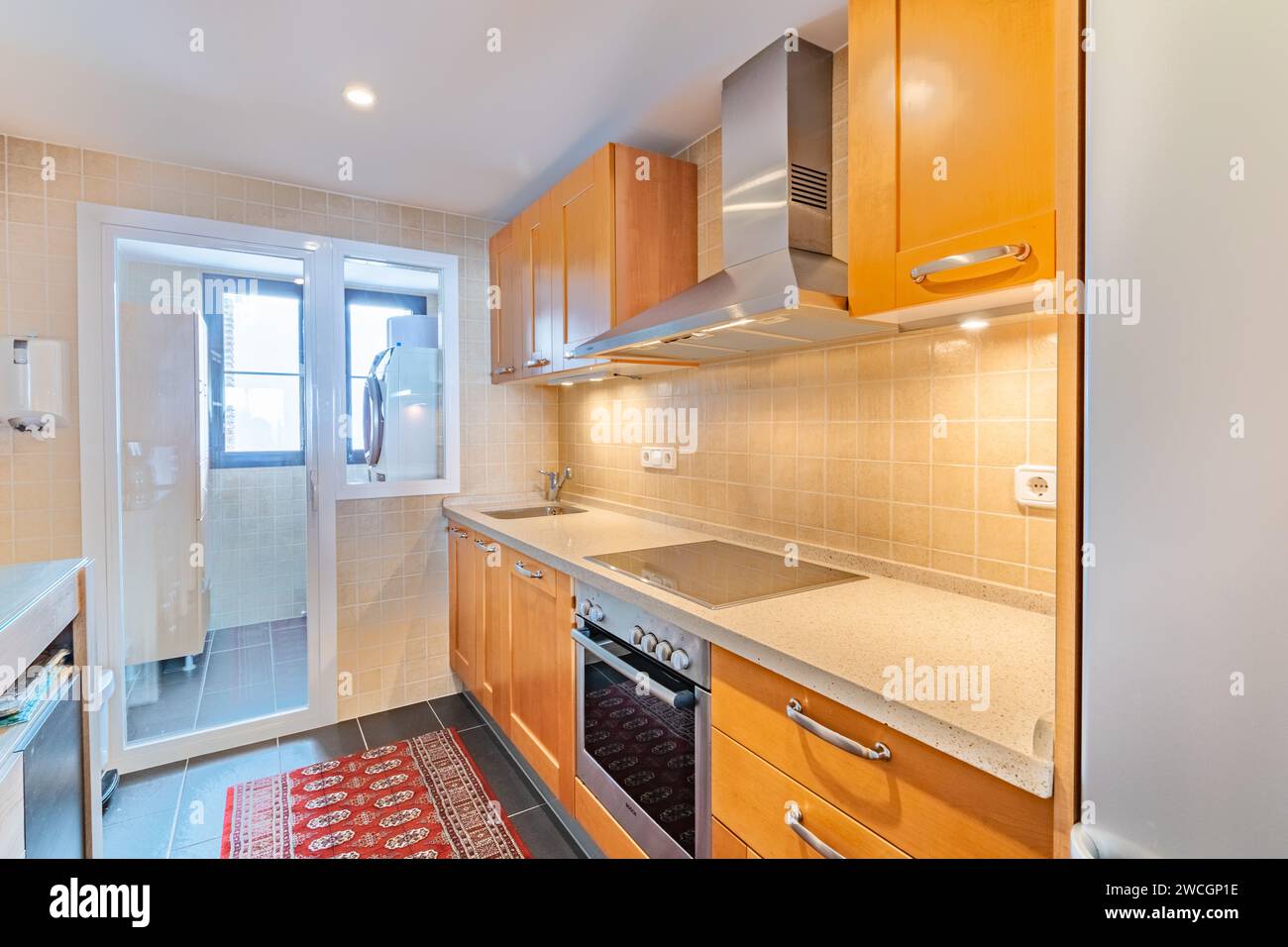 a kitchen with orange cupboard doors in a luxury mediterranean holiday ...