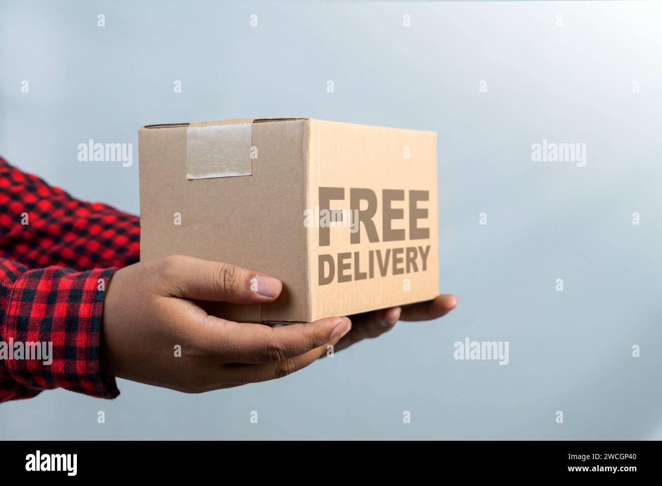 Human hand for packet delivery with free delivery text on a colored ...