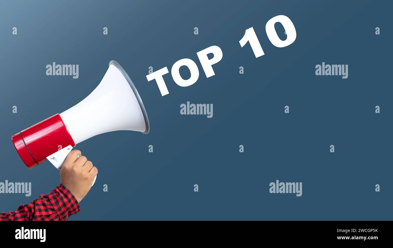 A human hand holding a megaphone with a Top 10 breaking news symbol on ...