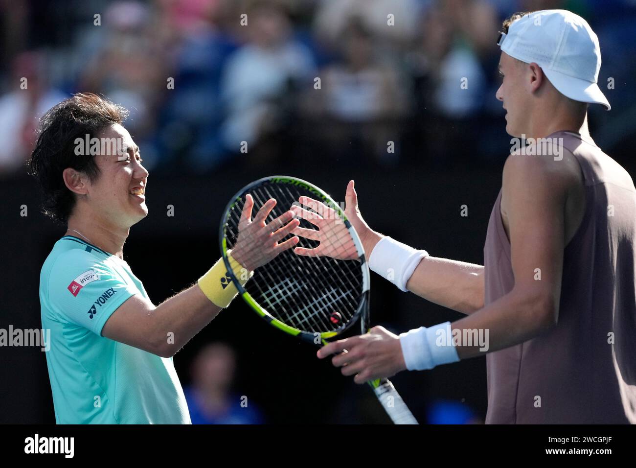 Holger Rune, right, of Denmark is congratulated by Yoshihito Nishioka ...
