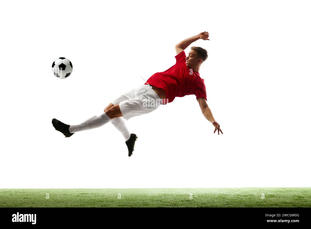 Elevated excellence. Soccer maestro kicks ball into air, showcasing ...