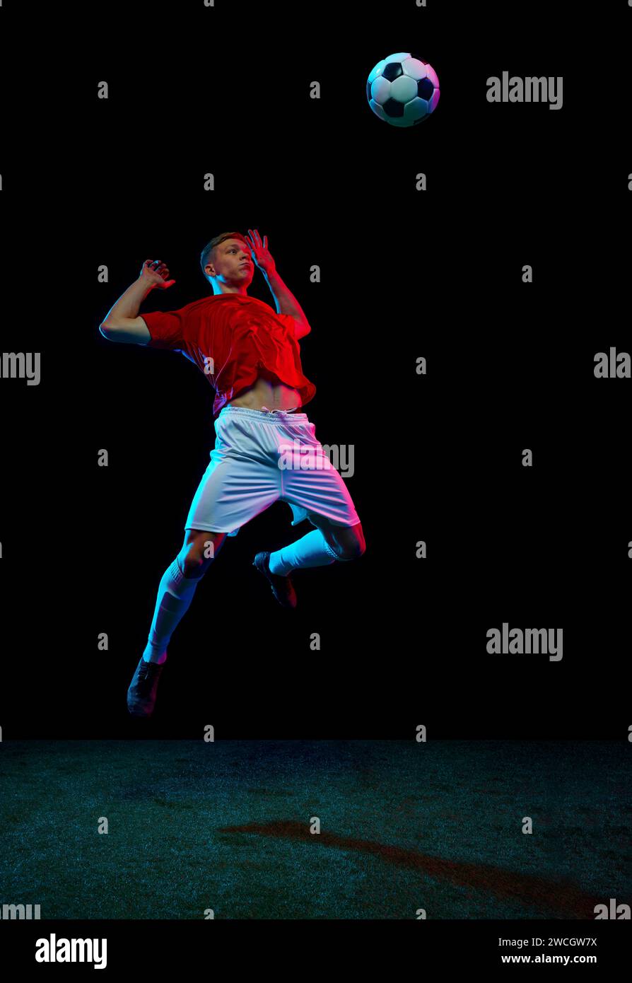 Airborne Mastery. Portrait of soccer as professional player executes ...