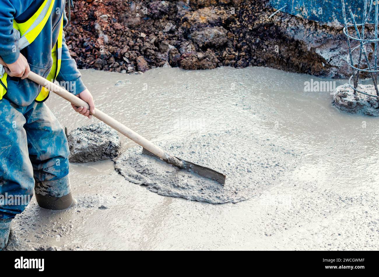 Builder pouringfoundation for a lift shaft with wet ready-mix concrete ...